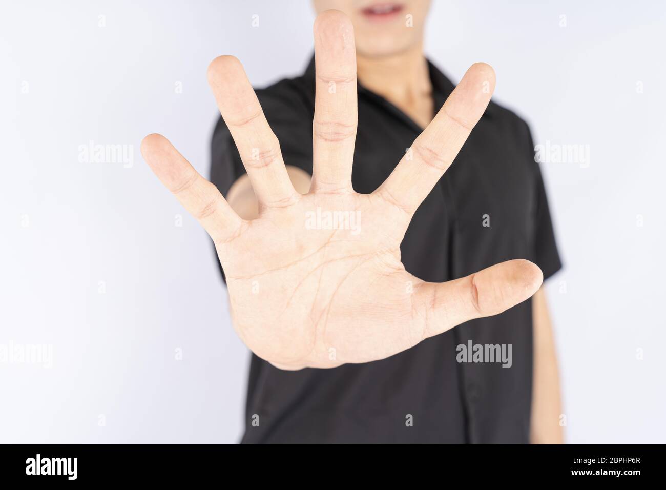 Man raised his hand for stop smoking.No smoking sign painted. No ...