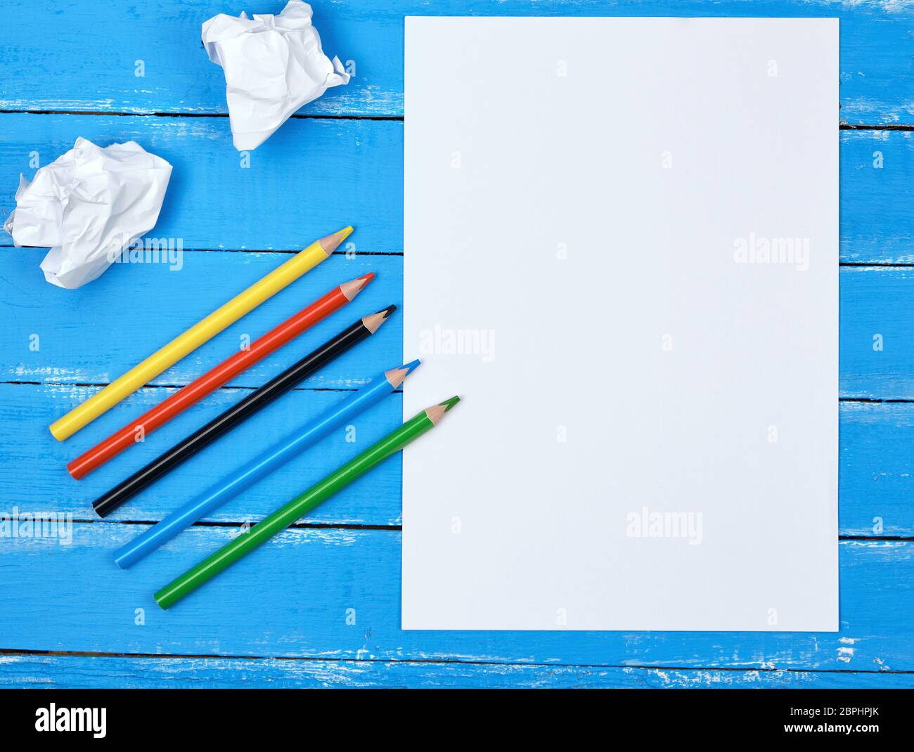 blank white rectangular sheet of paper and crumpled pieces of paper and ...