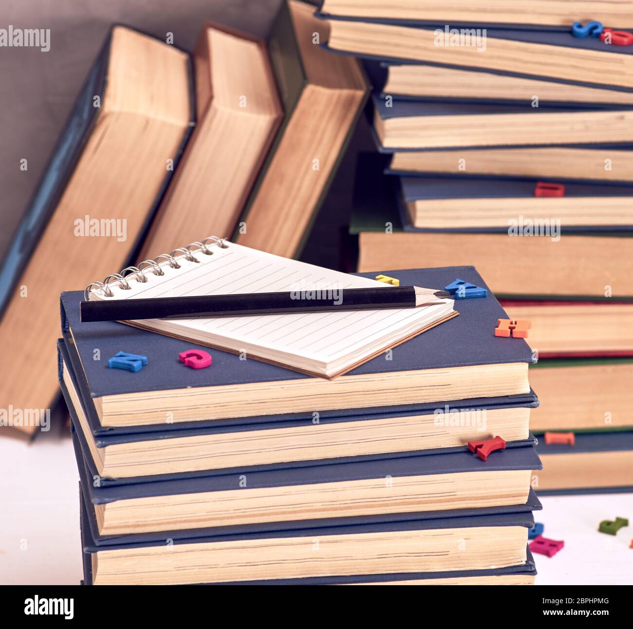 empty notebook with white sheets and many different books, close up ...