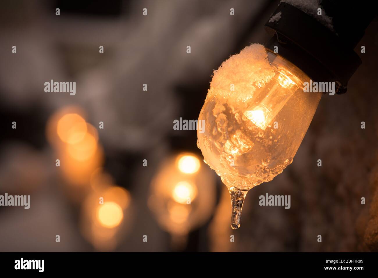 Color image of a frozen lit light bulb Stock Photo - Alamy