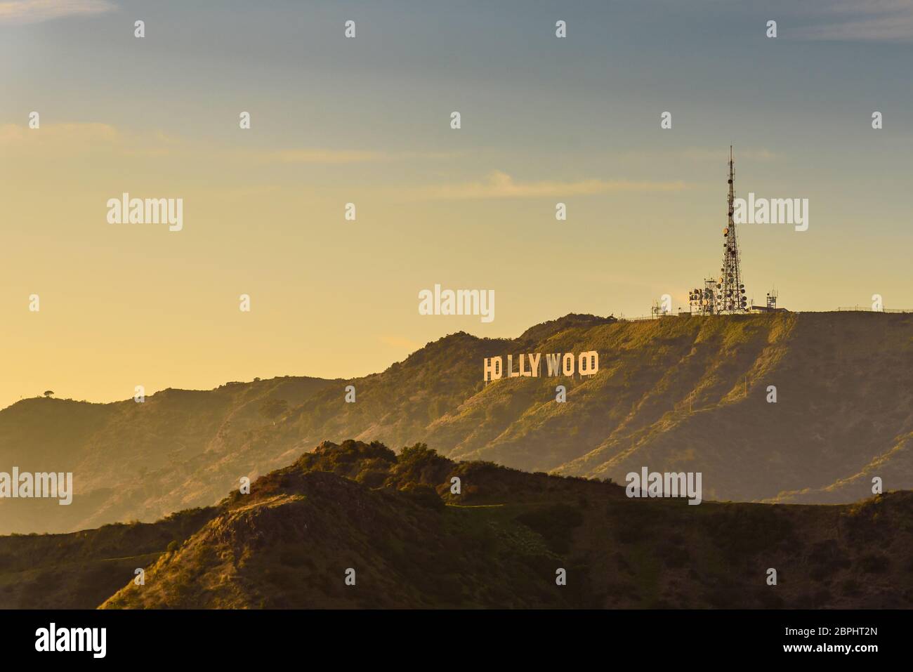 Hollywood sign, Los Angeles, bathed in a golden light from the setting ...