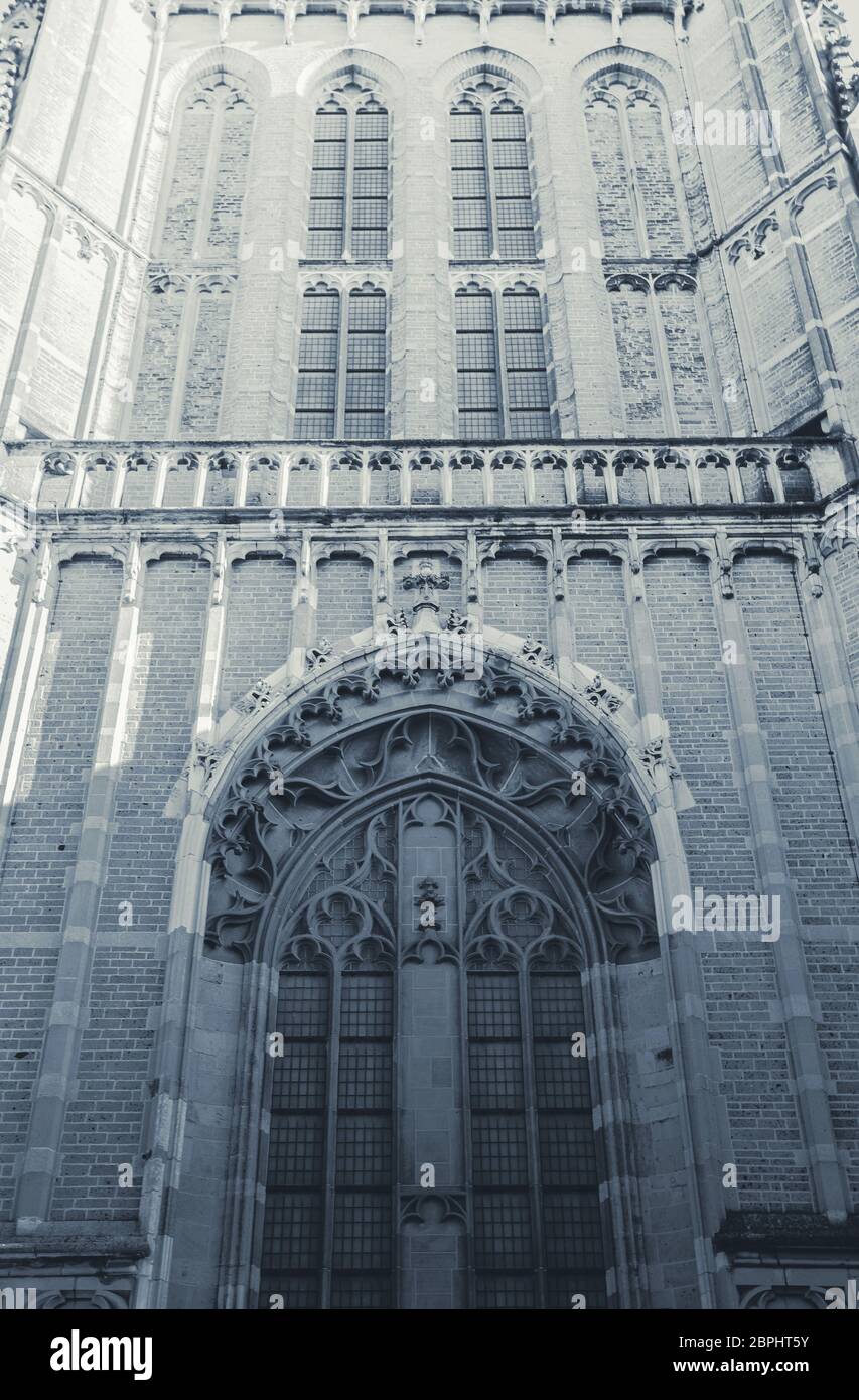 front view of a big church with a tower and clock close-up black and ...