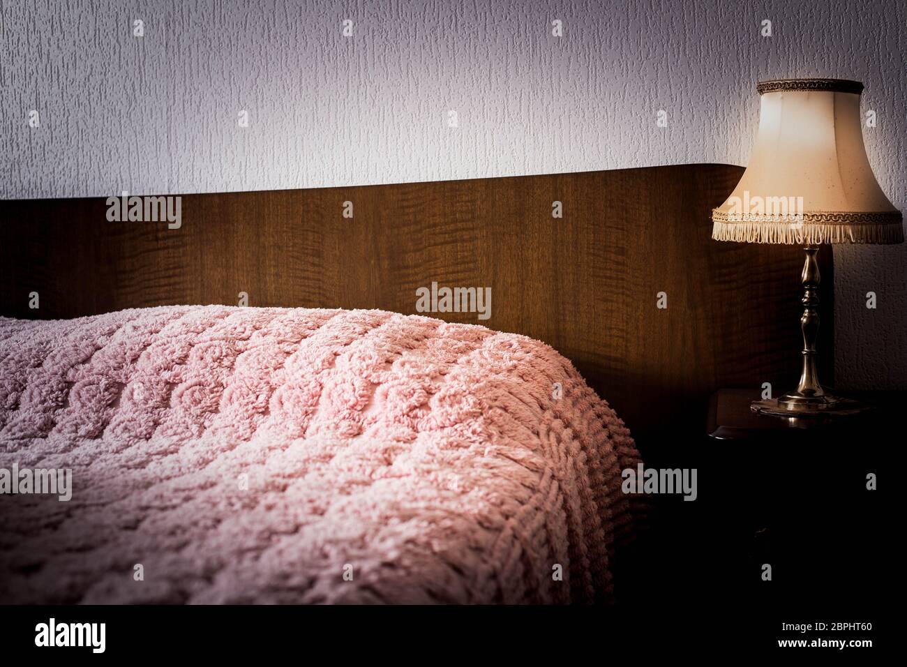 Vintage interior with antique night light, bed, wooden nightstand and ...
