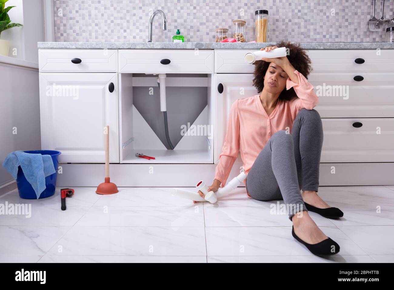 Disappointed African Young Woman Holding Broken Sink Pipe In Hand ...