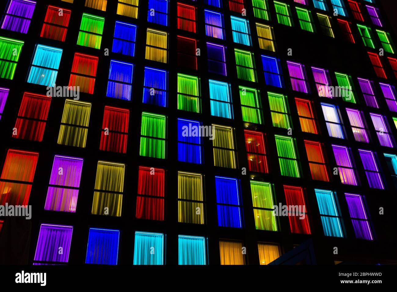 Colored windows texture. Windows illuminated by neon lights background ...