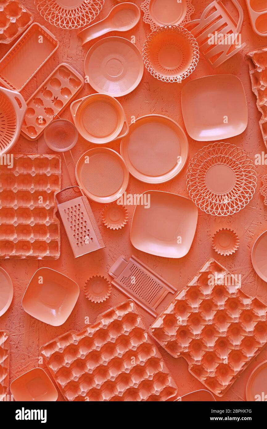 Close up flat lay of different orange color painted kitchen utensils ...
