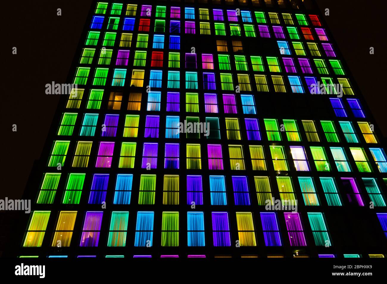 Colored windows texture. Windows illuminated by neon lights background ...