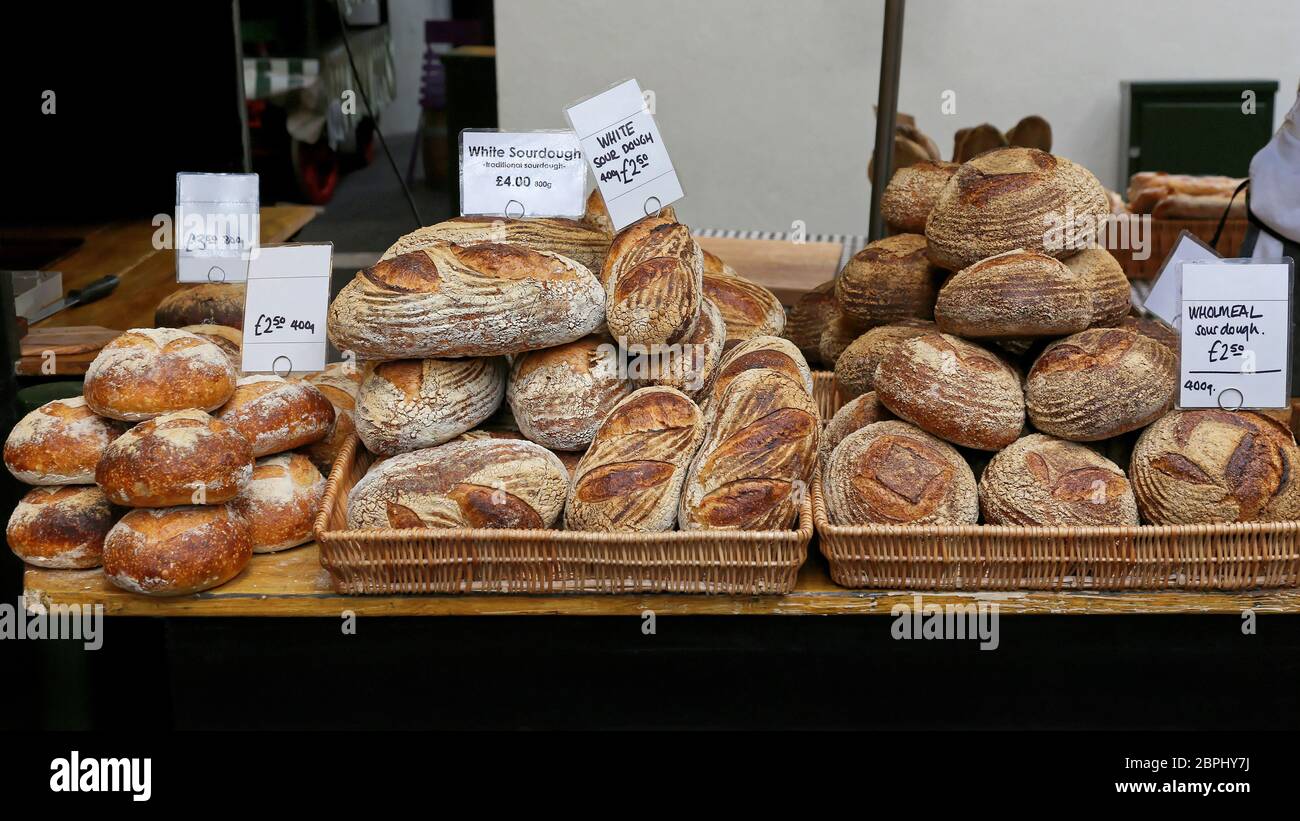 Loaves of Artisan Bread at Table in Bakery Shop Stock Photo - Alamy