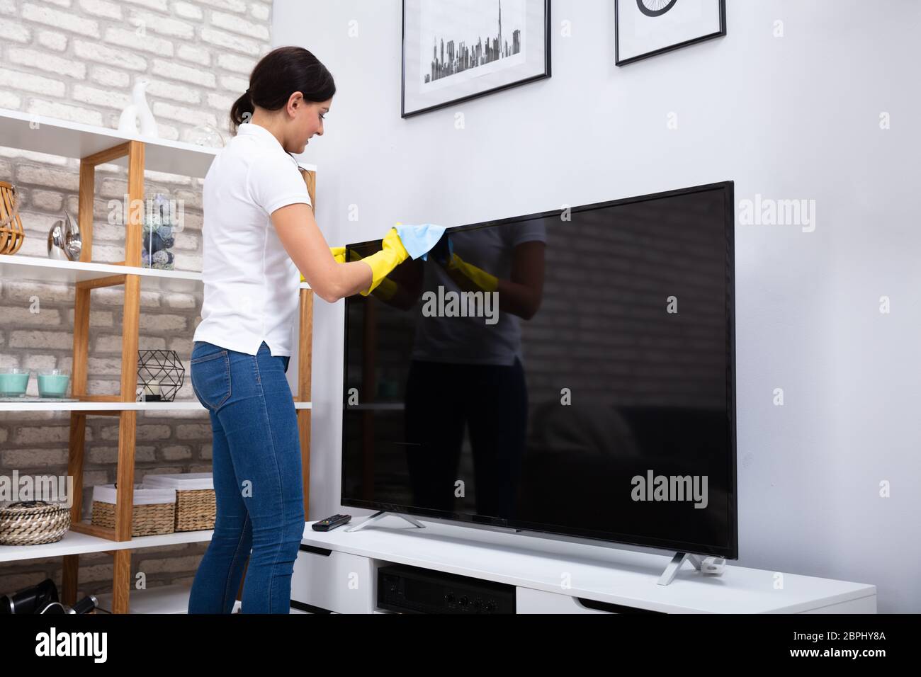 Woman standing tv wall hi-res stock photography and images - Alamy
