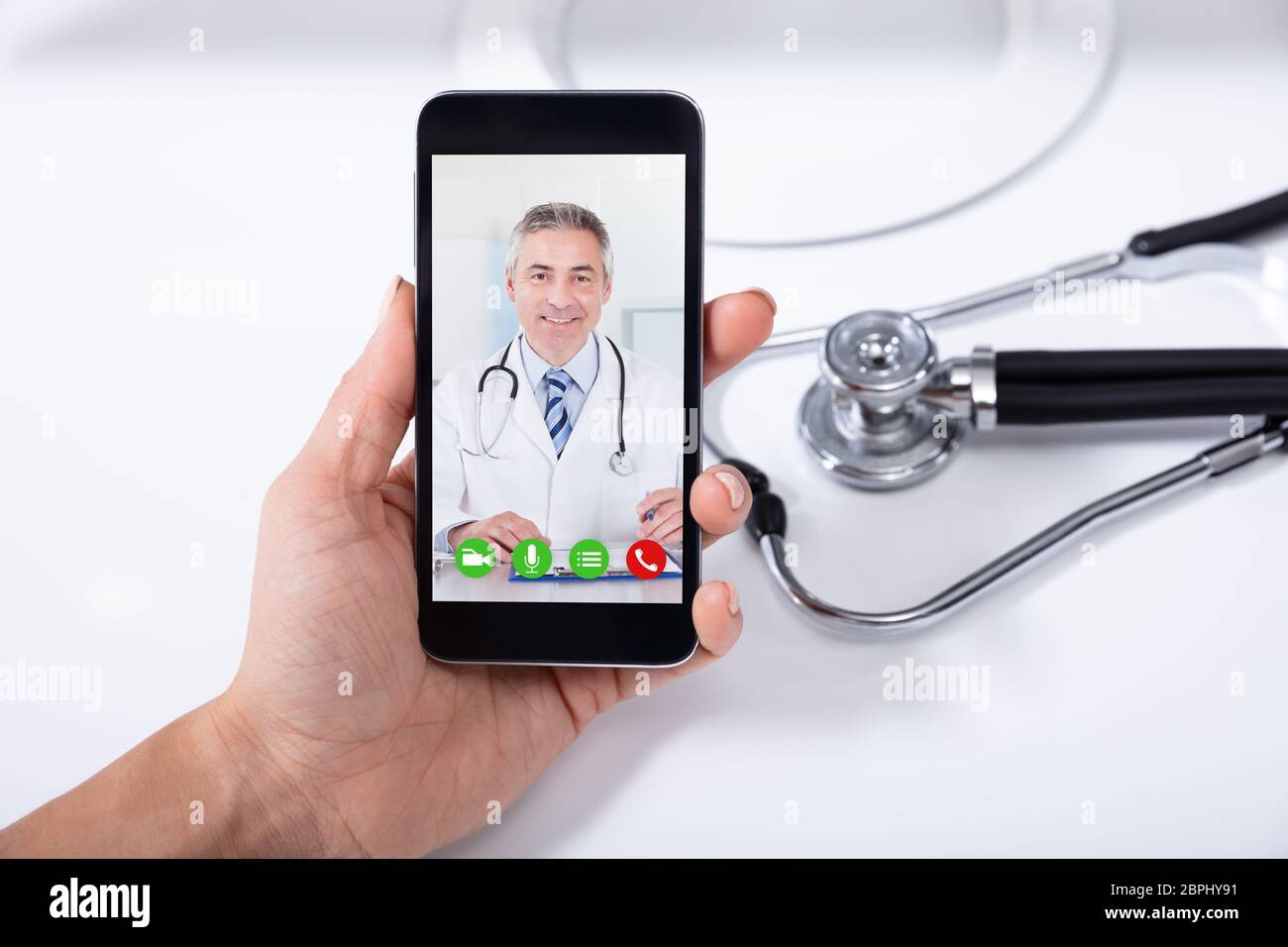 Doctor holding video conference colleague hi-res stock photography and ...