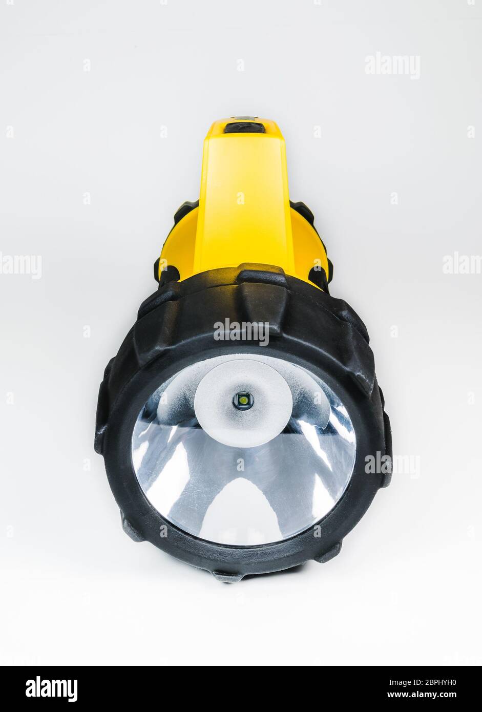 big yellow flashlight hand held with adjustable angle isolated on white ...