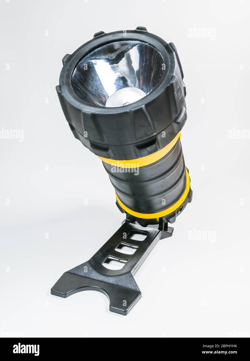 big yellow flashlight hand held with adjustable angle isolated on white ...