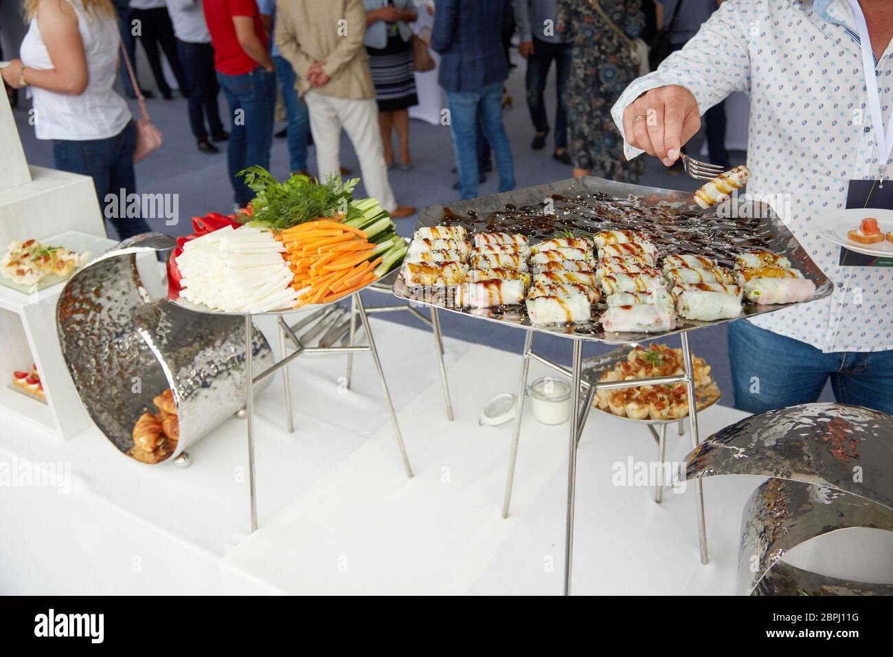 men in blue suits choosing food at a banquet Stock Photo - Alamy