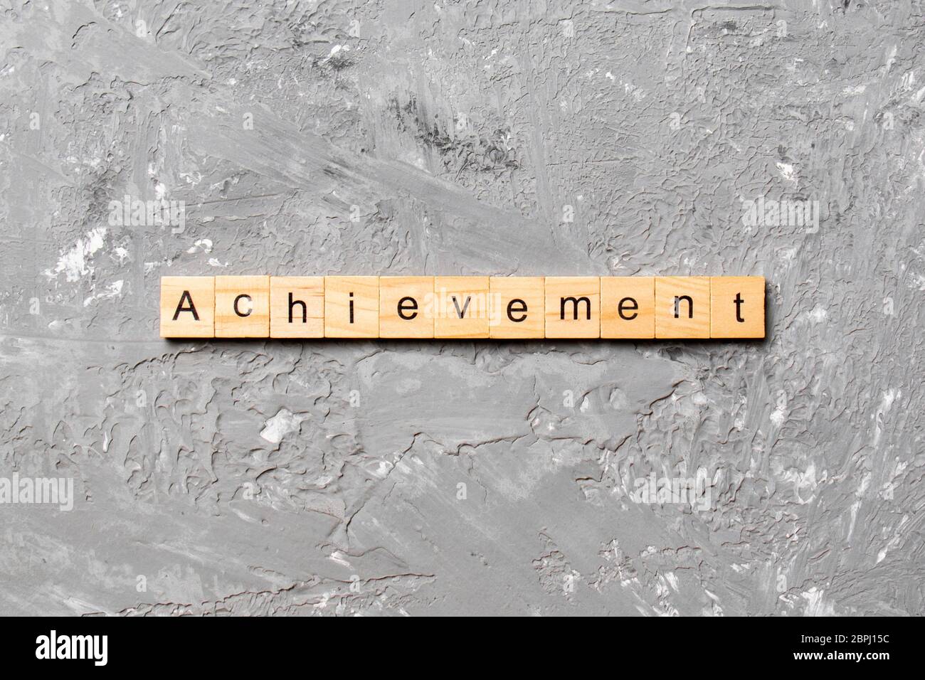 achievement word written on wood block. achievement text on table ...