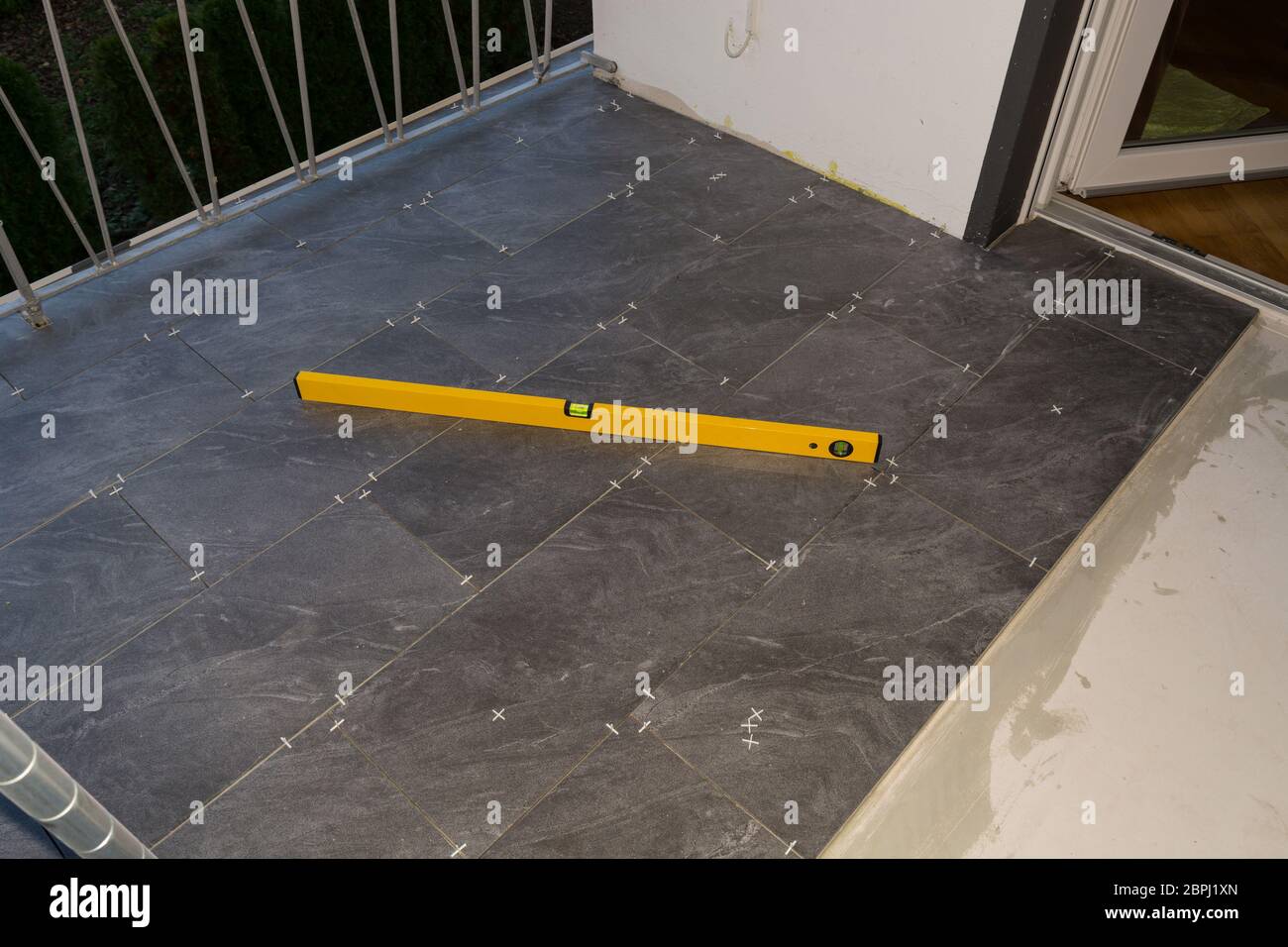 Balcony floor tiles installation. Laying tiles from porcelain. Interior ...