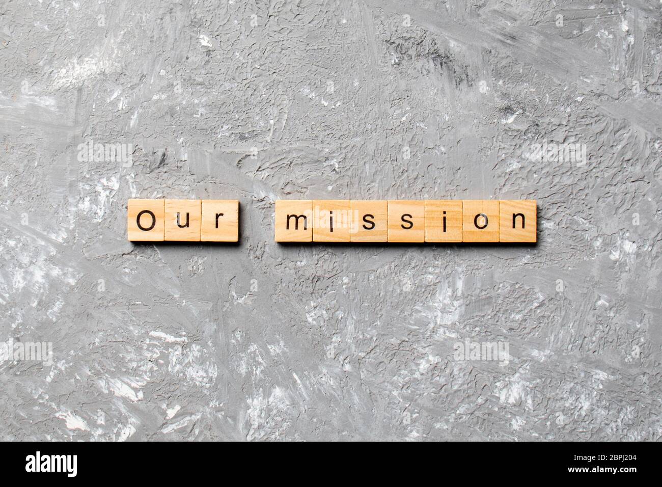 our mission on word written on wood block. our mission text on table ...
