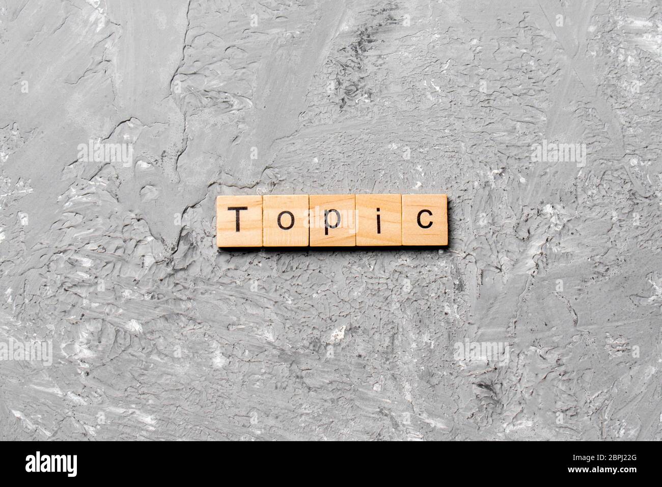 topic word written on wood block. topic text on cement table for your ...