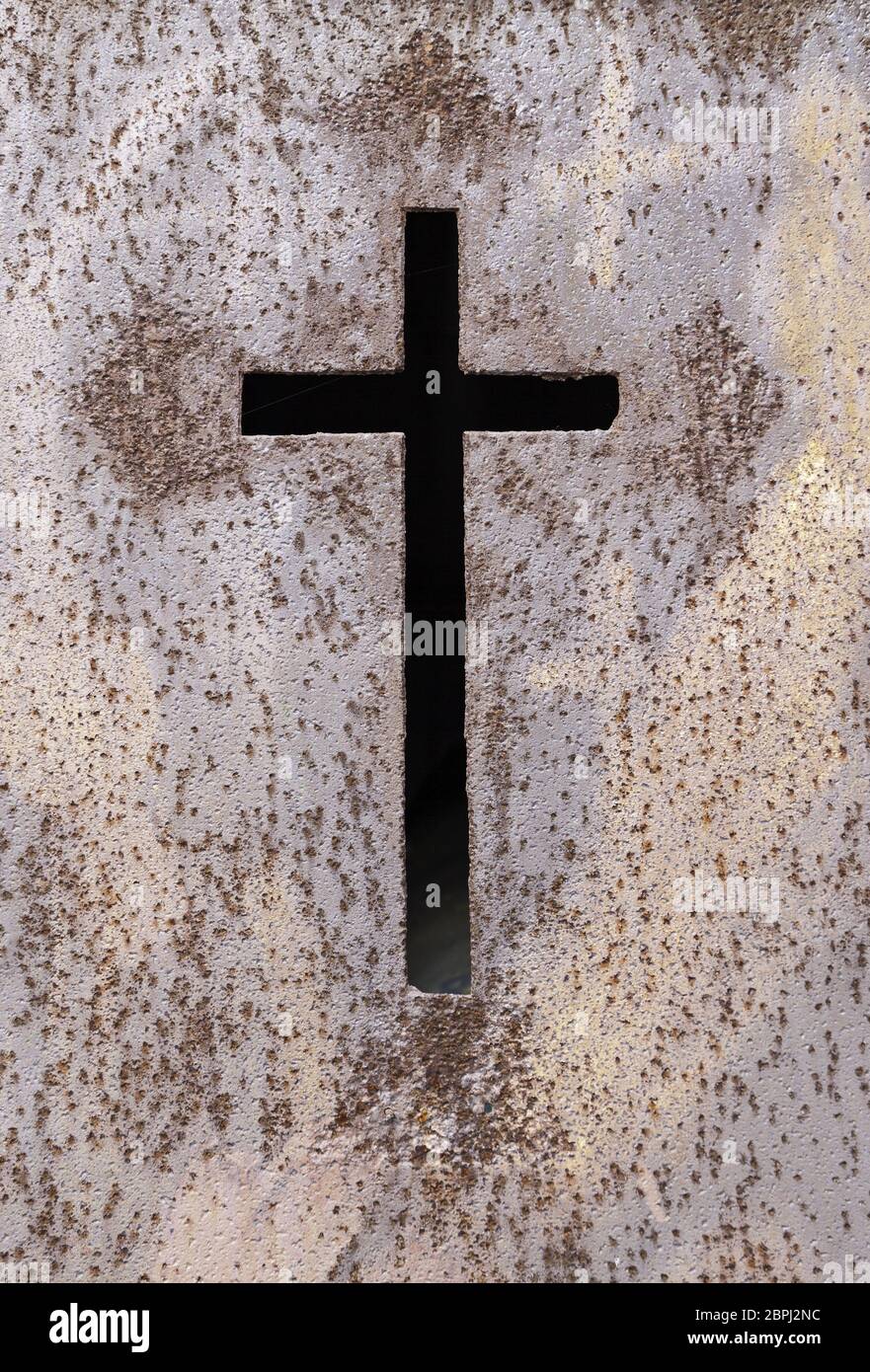 Old rusty metal cross, detail of an old cross on a metal wall, cemetery ...