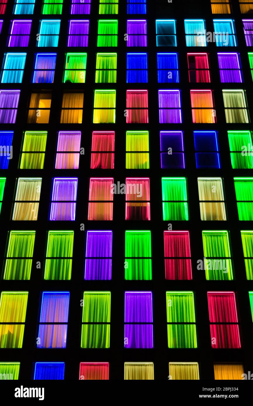 Colored windows texture. Windows illuminated by neon lights background ...