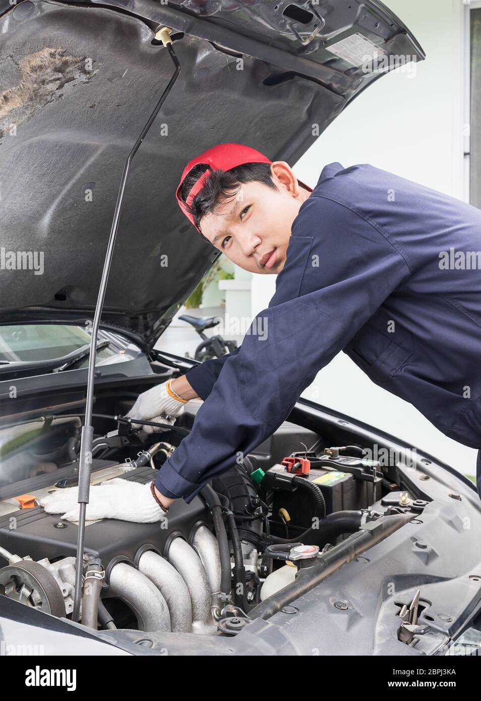 Auto mechanic check engine car at work in his garage Stock Photo - Alamy