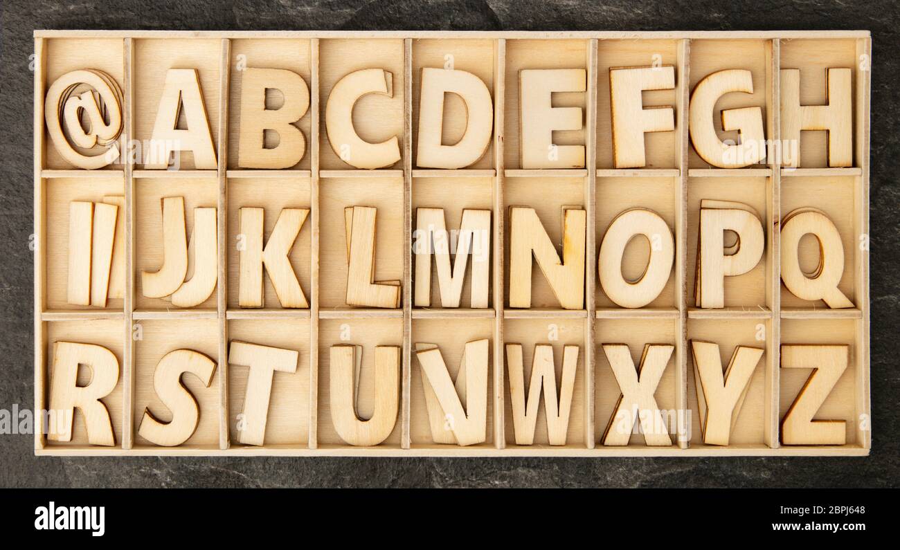 Wooden toy letters in a Box on dark background Stock Photo - Alamy