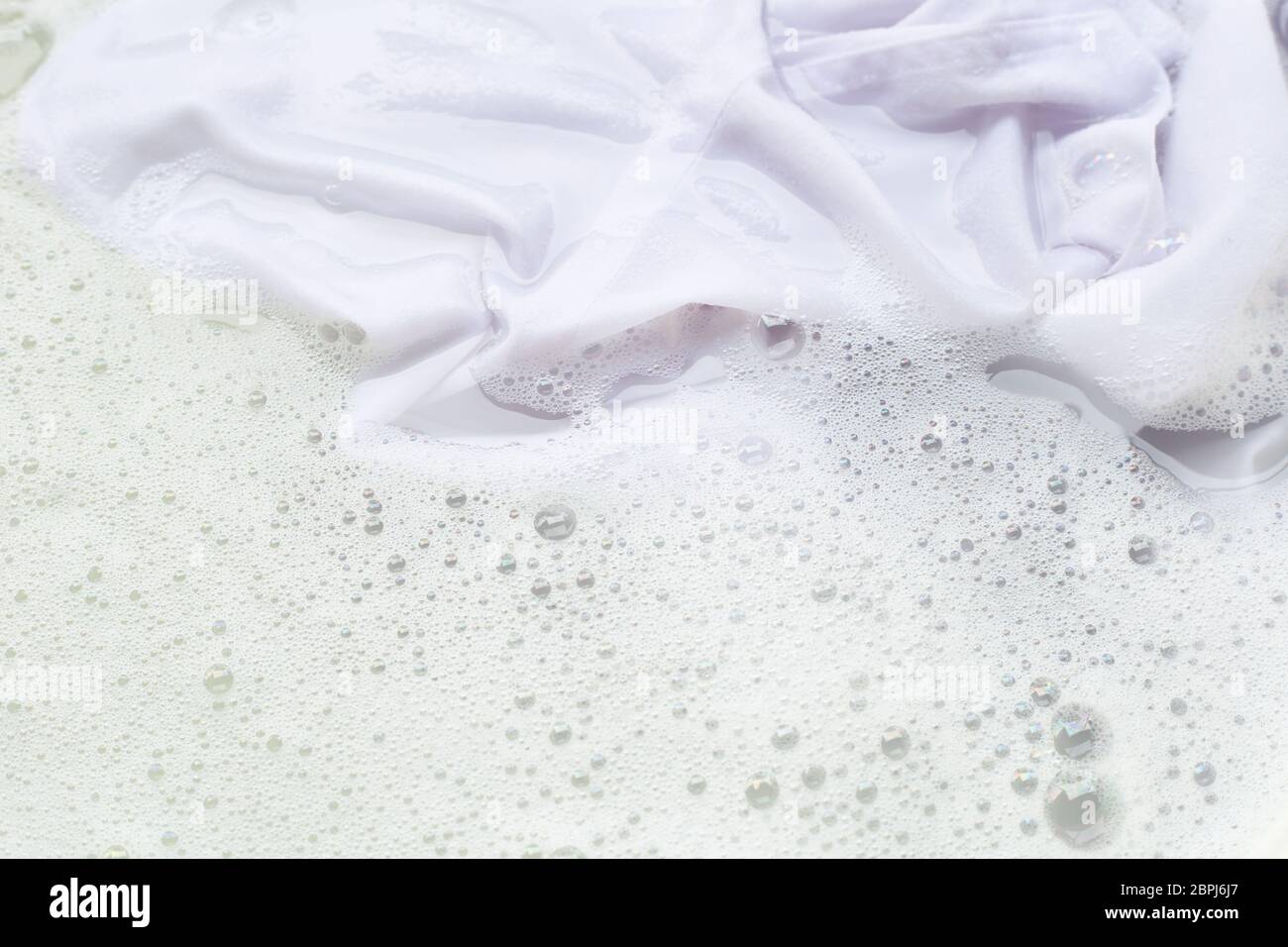Soak a cloth before washing, white shirt Stock Photo - Alamy