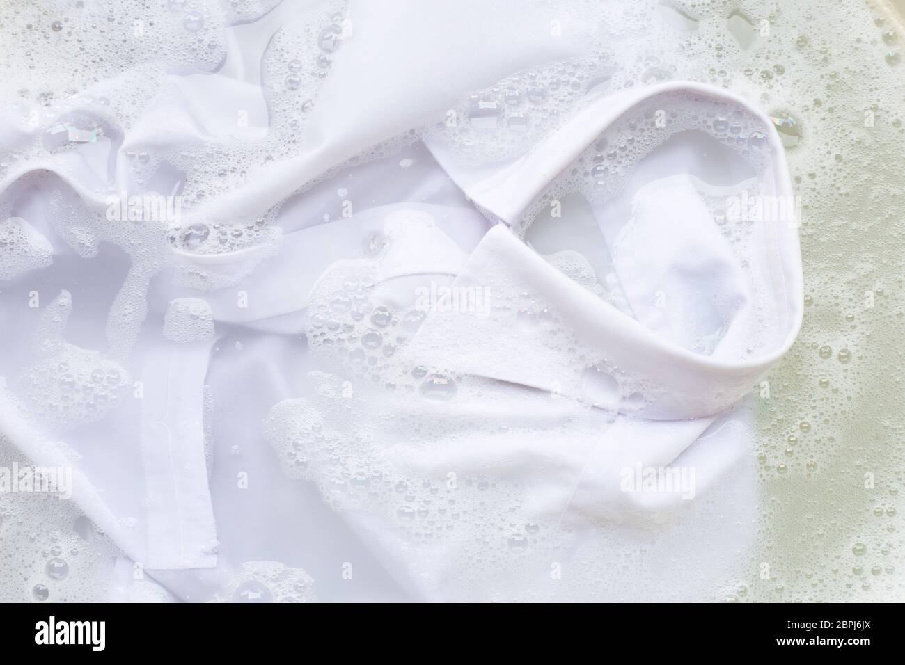 Soak a cloth before washing, white shirt Stock Photo - Alamy