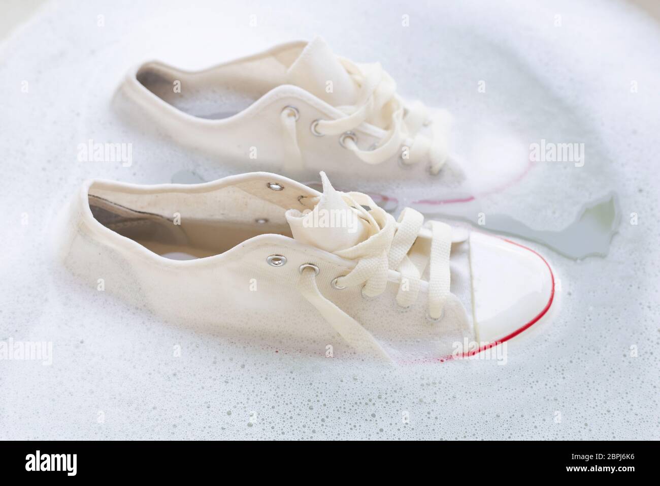 Soak shoes before washing. Cleaning Dirty sneakers Stock Photo - Alamy