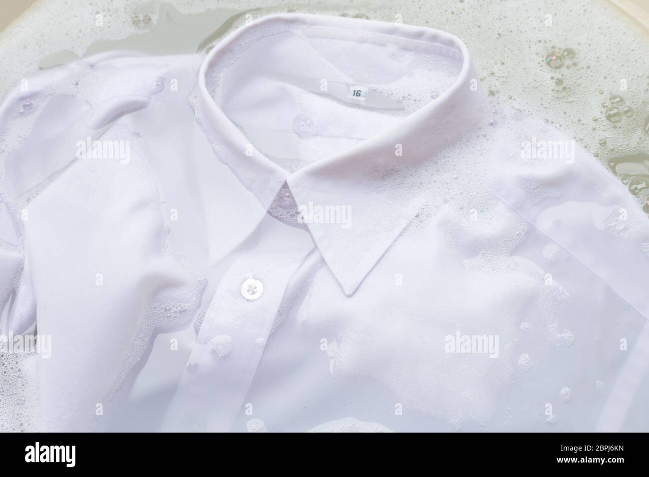 Soak a cloth before washing, white shirt Stock Photo - Alamy