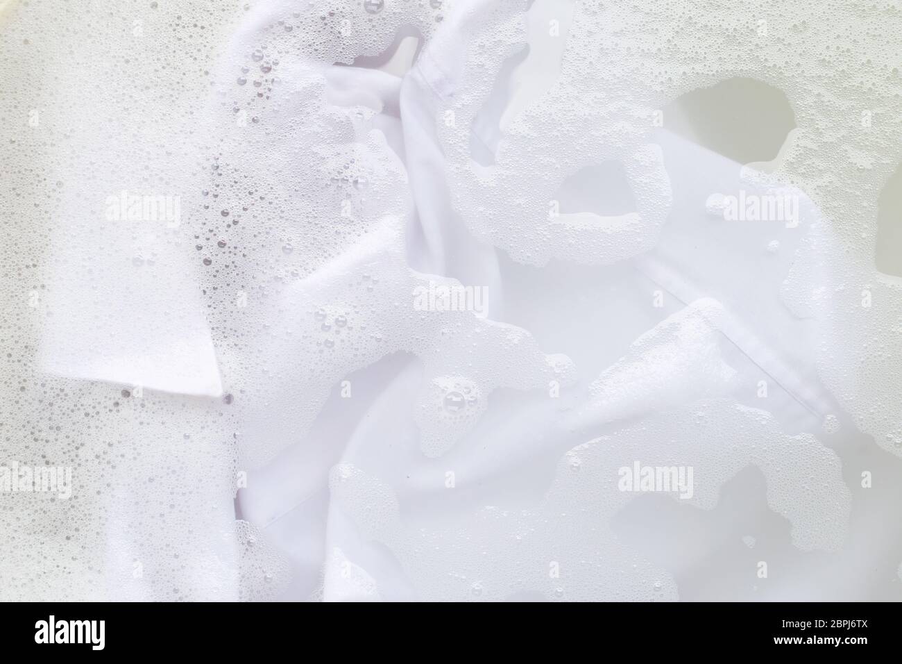 Soak a cloth before washing, white shirt Stock Photo - Alamy