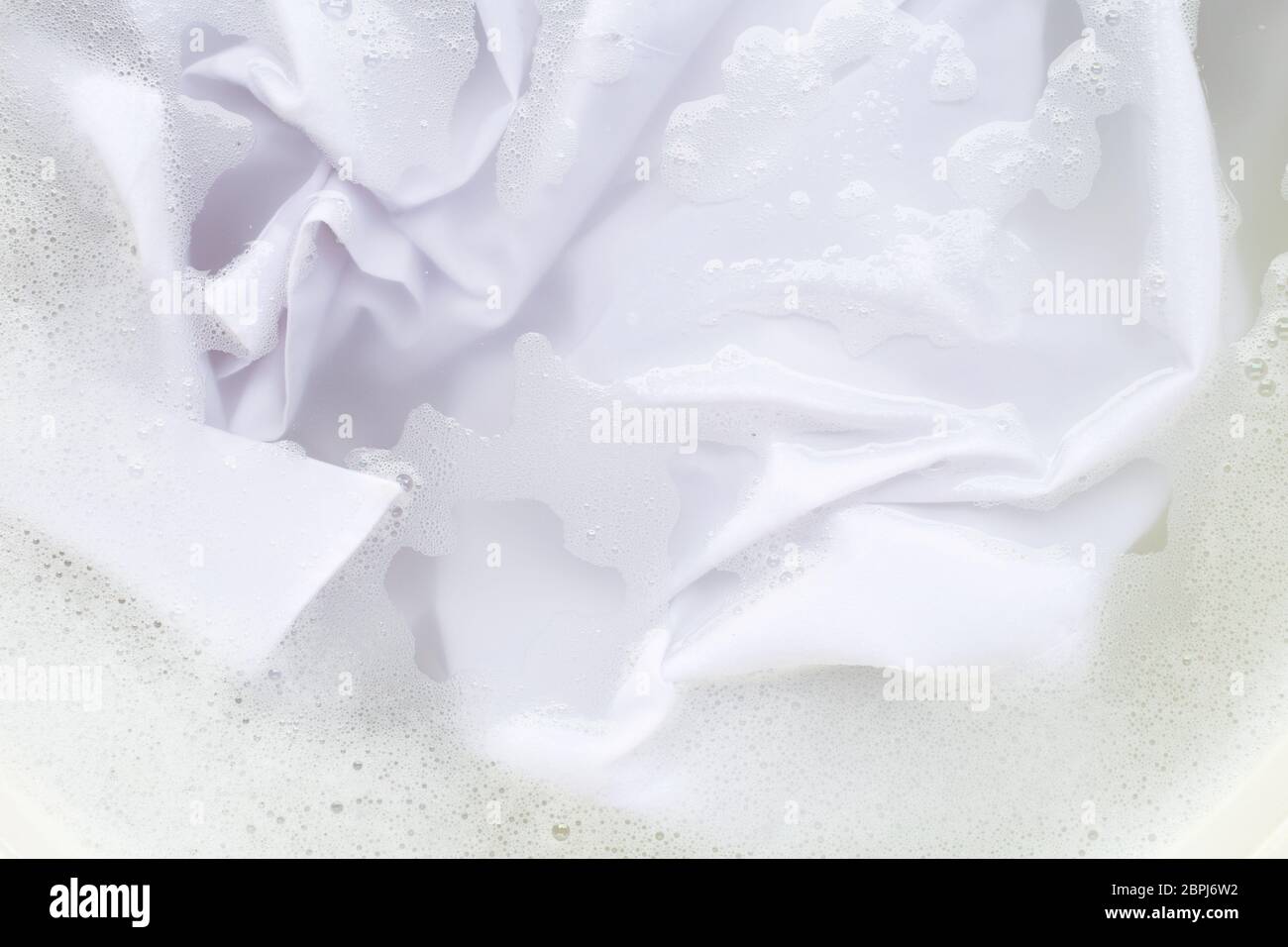 Soak a cloth before washing, white shirt Stock Photo - Alamy
