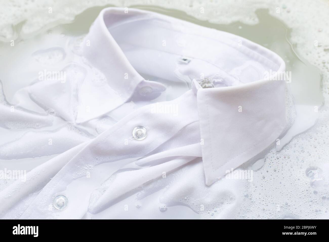 Soak a cloth before washing, white shirt Stock Photo - Alamy