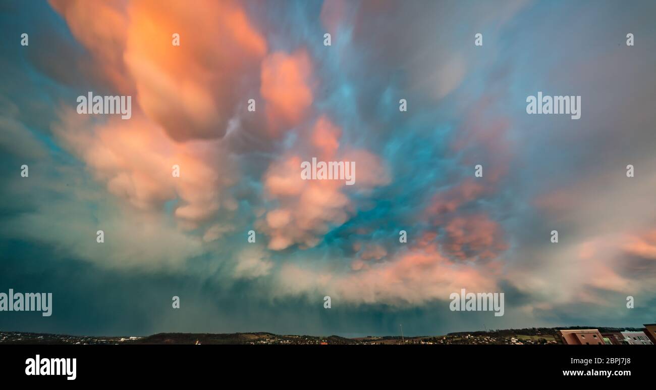 Dramatic sky with thunderclouds. Pink Clouds Illuminated by the Rays of ...