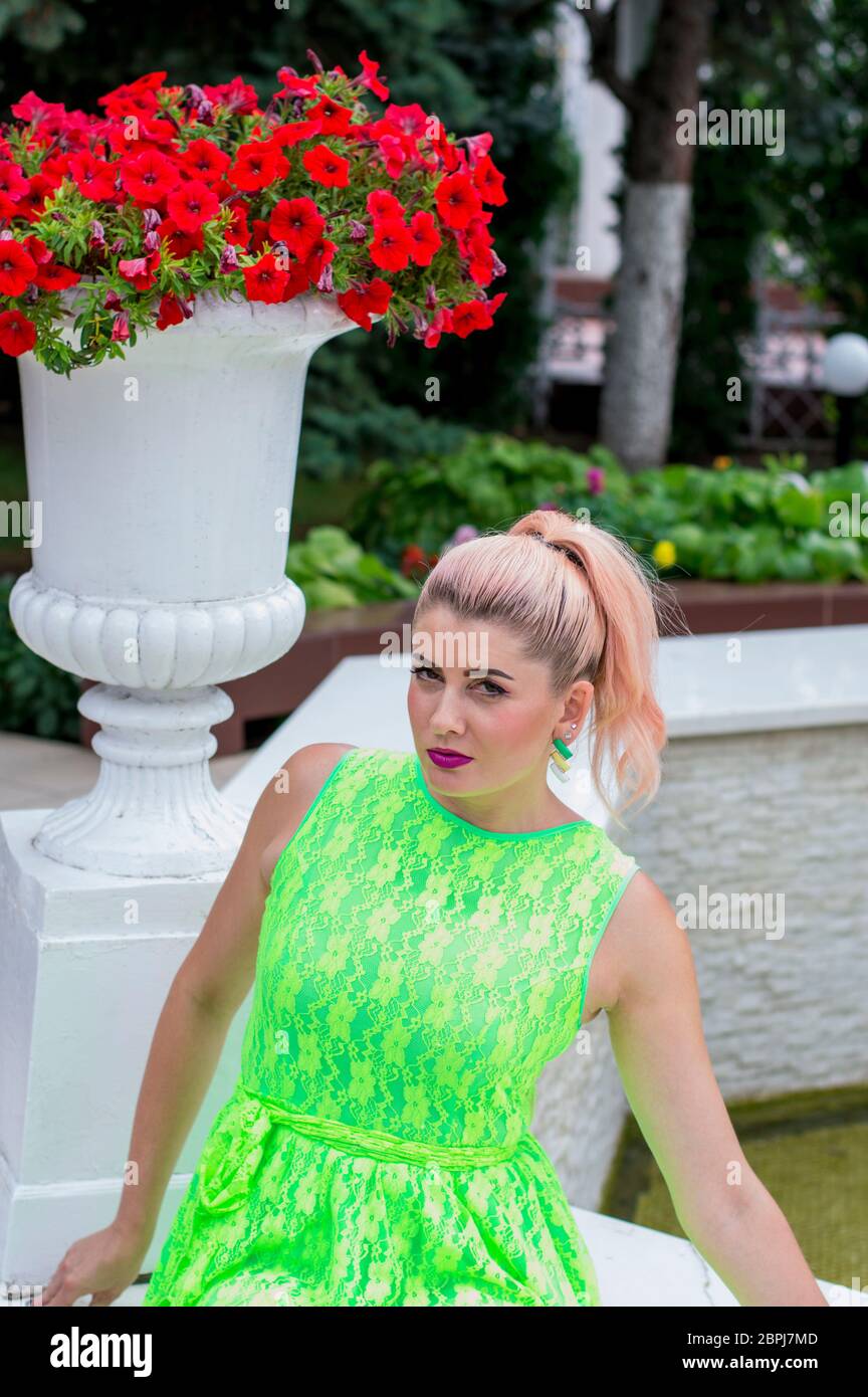 woman summer sitting at the flowerpot with Petunia, the theme of ...