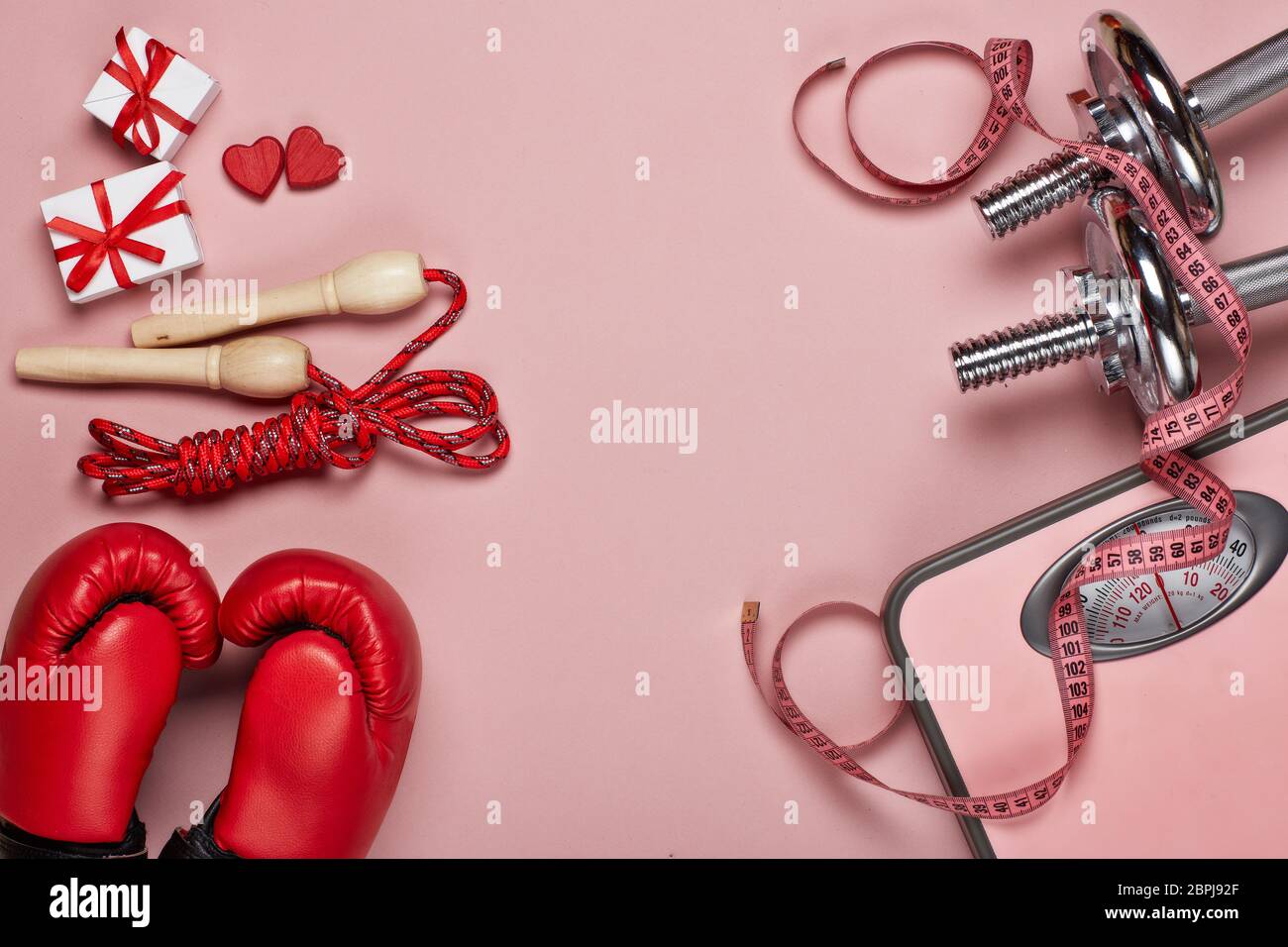 Dumbbells, boxing gloves, scales, skipping rope, gift boxes and red ...