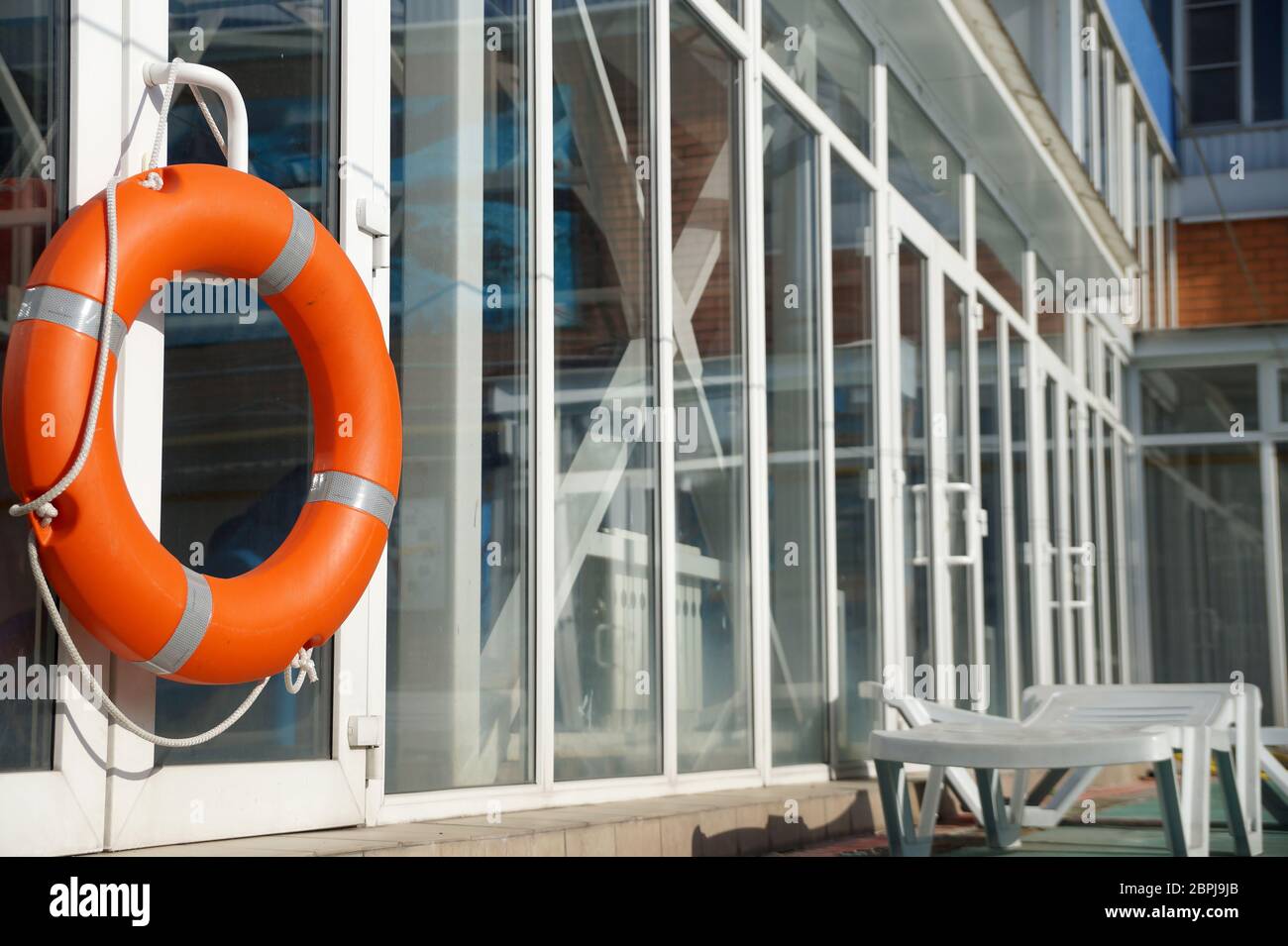 Orange lifebuoy on a wall of a protection of the swimming pool Stock ...