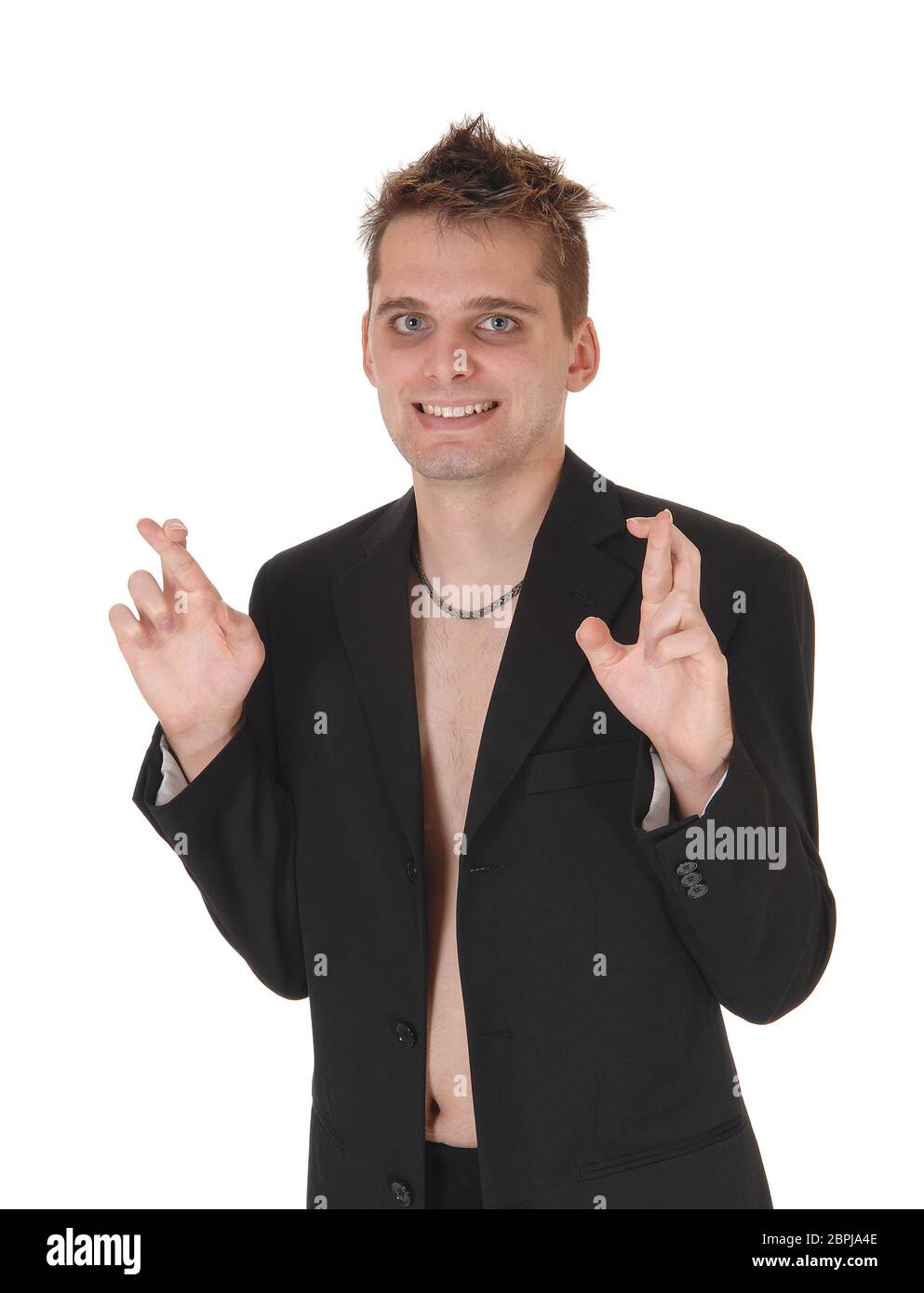 A smiling young man in a dark jacket but without a shirt standing with ...