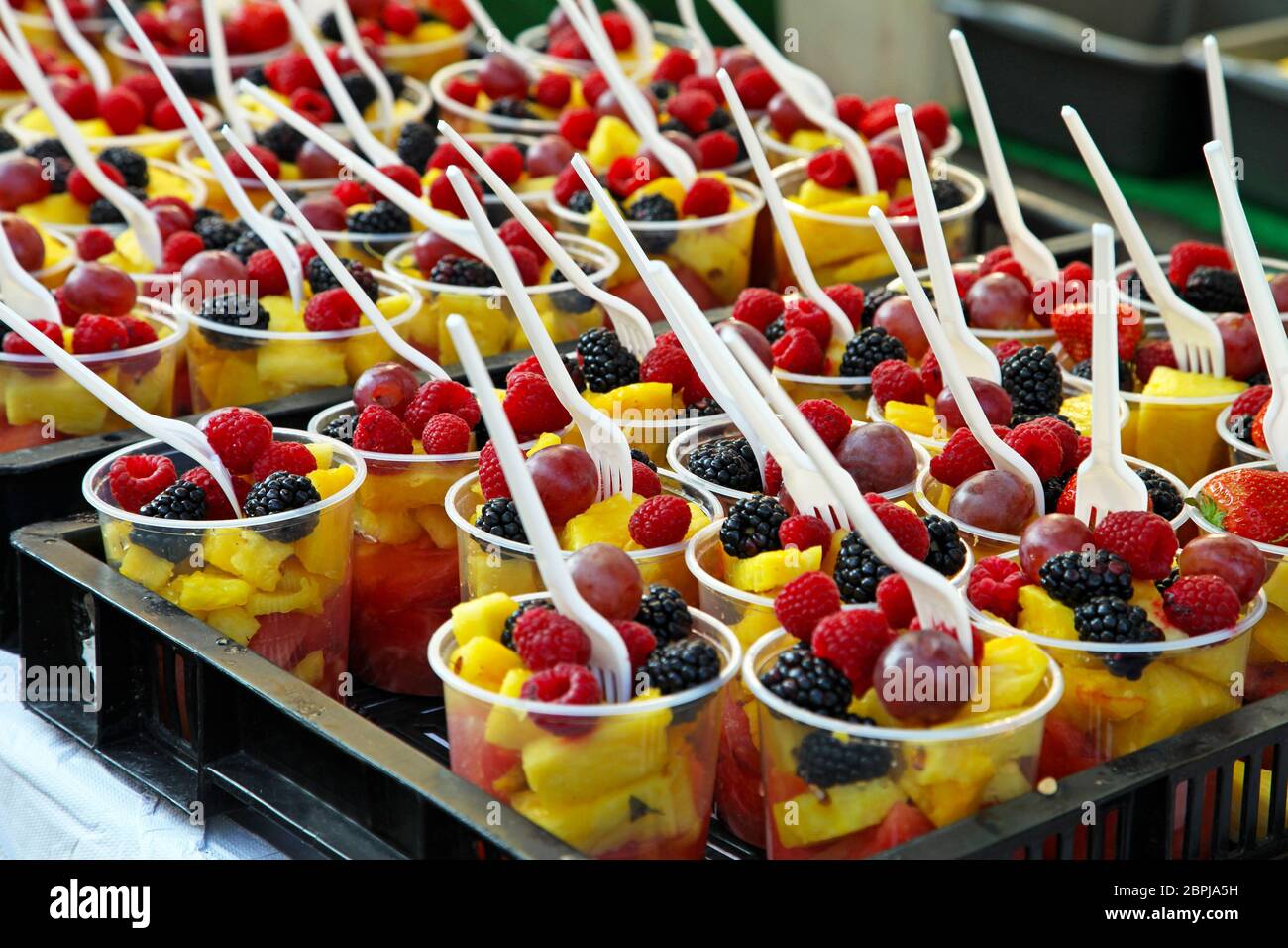 Prepared fruit salad in cups with forks Stock Photo - Alamy