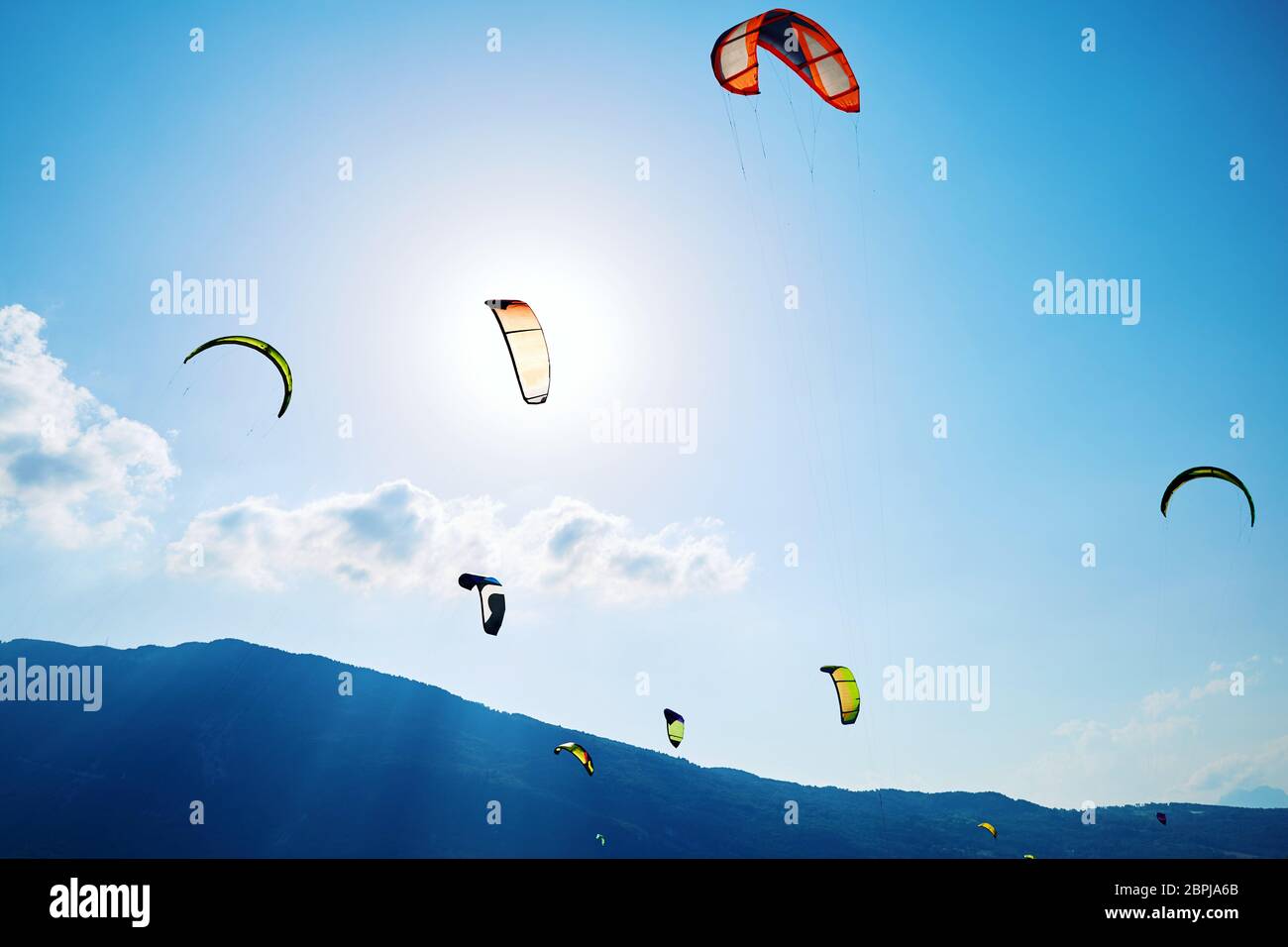 Colorful paragliding formation above Santa Croce Lake. Belluno, Italy ...
