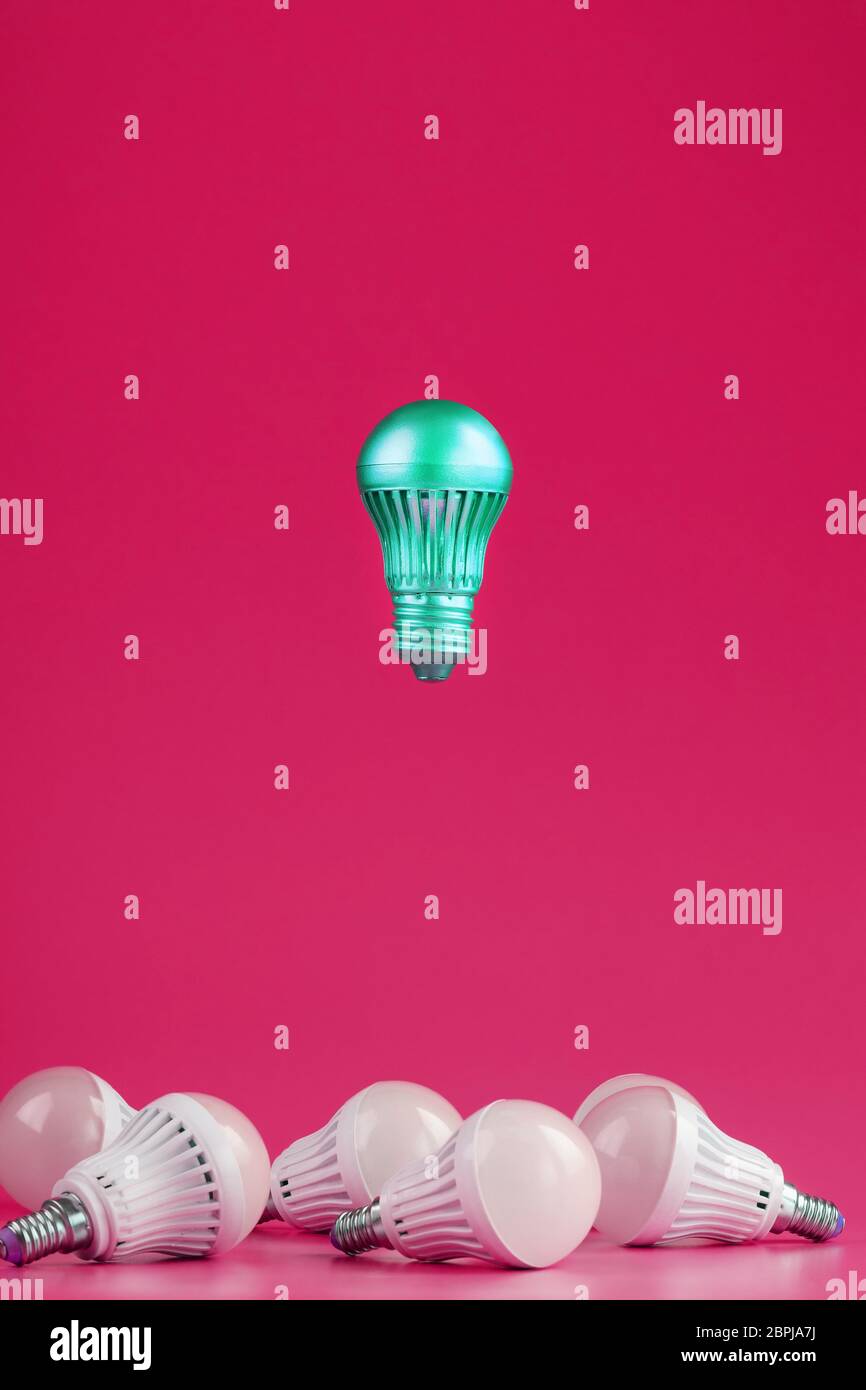 A special Light bulb hovers over simple, standard white light bulbs on ...