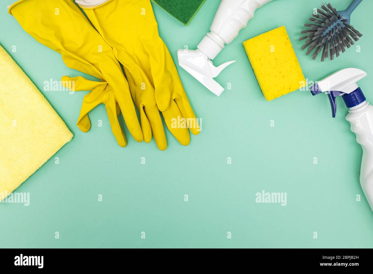 Cleaning tools and supplies on green background, top view Stock Photo ...