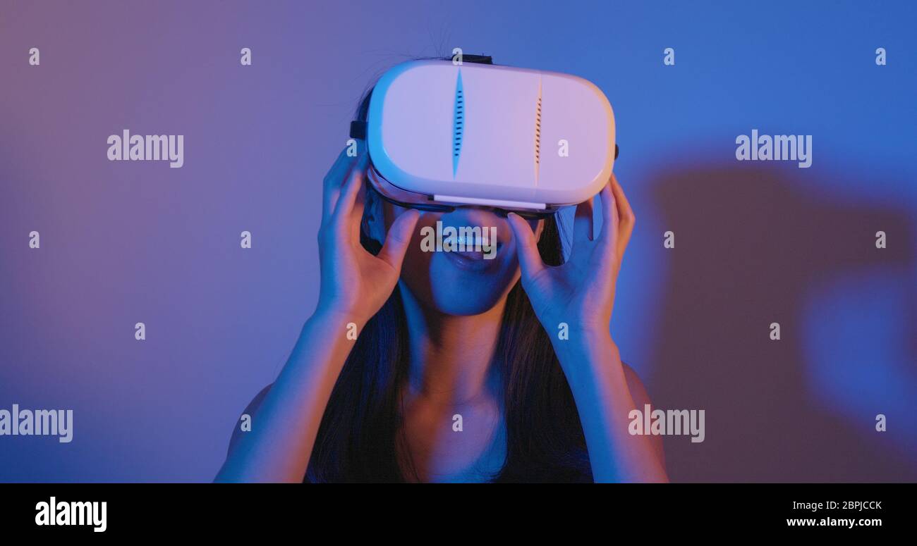 Woman watching with VR device with cyber lighting Stock Photo - Alamy