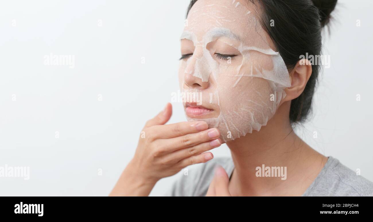 Woman apply mask on face Stock Photo - Alamy