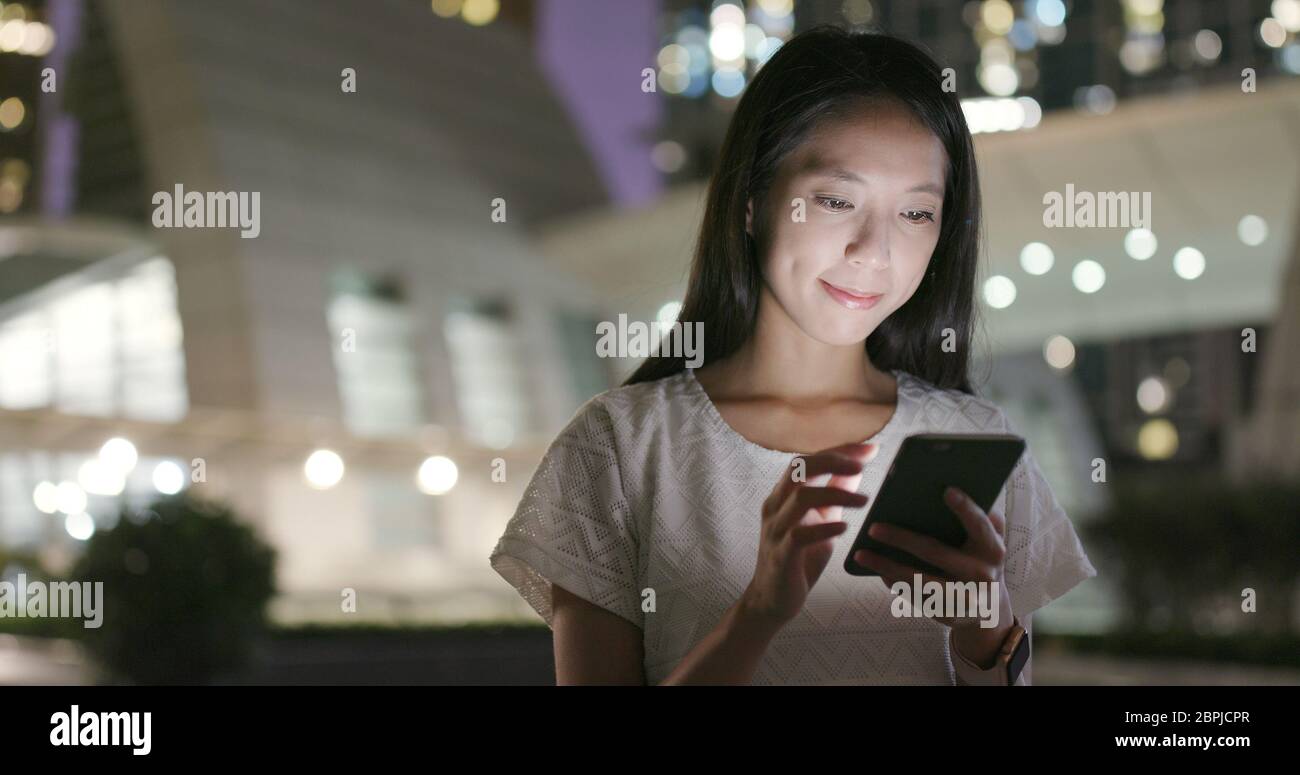 Busy woman work on mobile phone everywhere Stock Photo - Alamy
