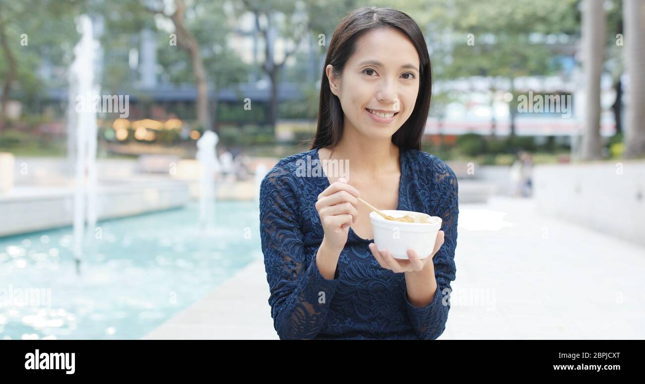Woman eating fish ball in Hong Kong, famous local food Stock Photo - Alamy
