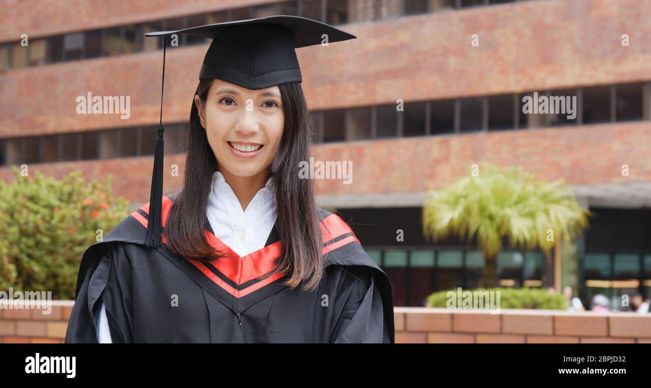 Graduation woman arm cross with wear graduation gown Stock Photo - Alamy