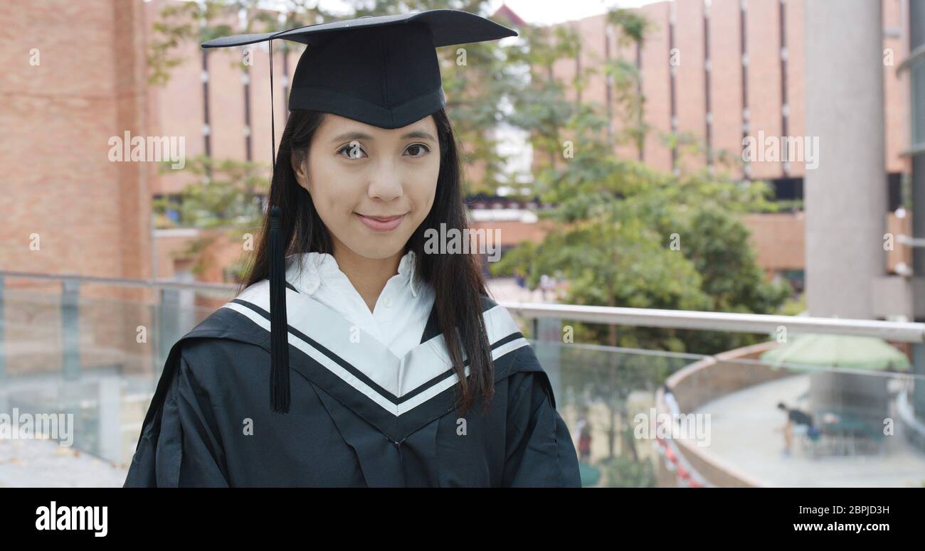 Woman wearing graduation gown Stock Photo - Alamy