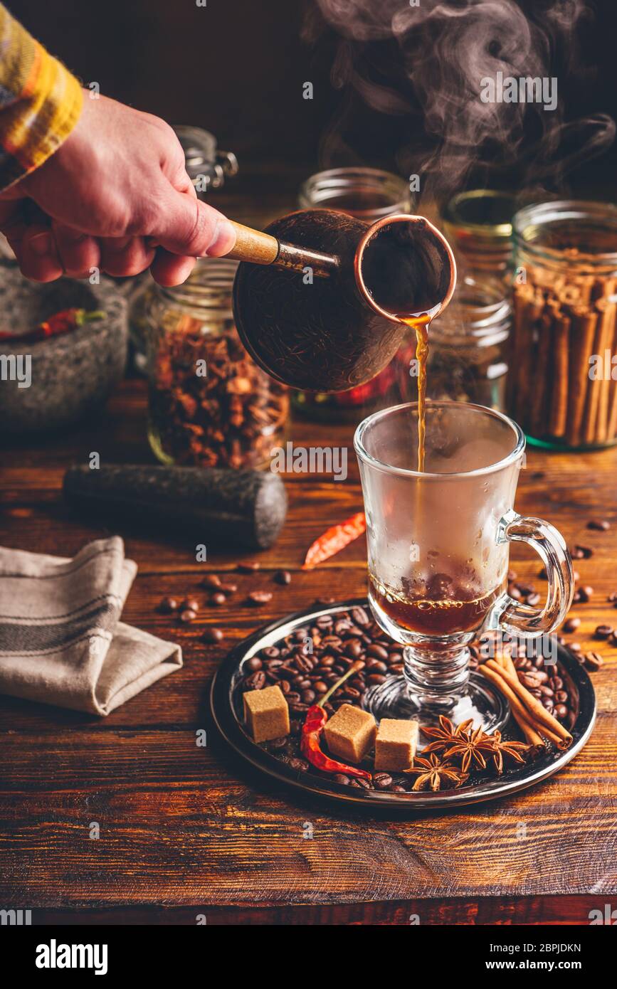 Man Pour Hot Soaring Coffee in Glass Mug. Oriental Spices and Coffee ...