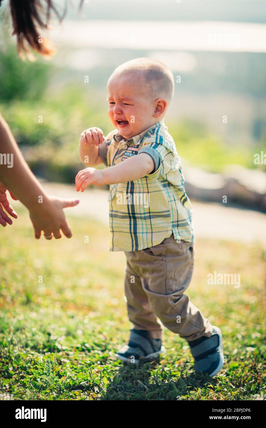 crying toddler baby on nature background Stock Photo - Alamy