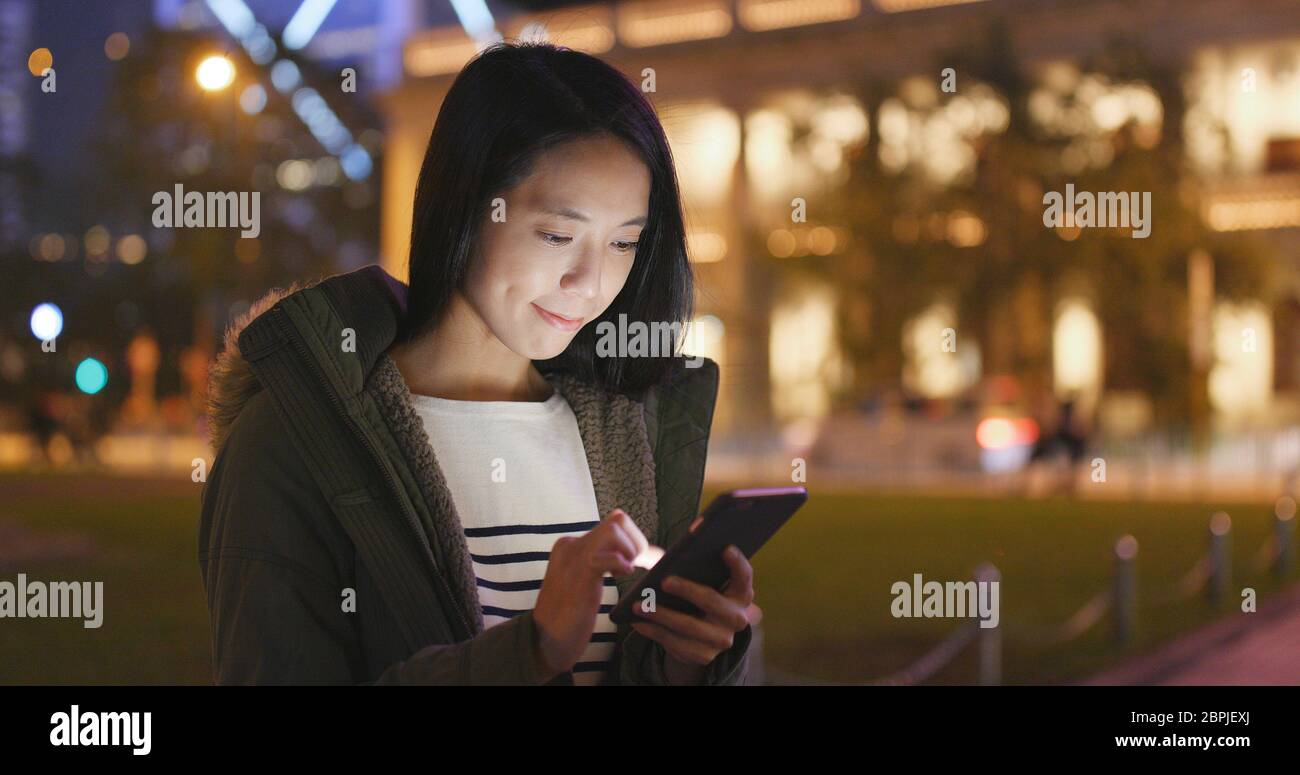 Woman sending message on mobile phone at outdoor Stock Photo - Alamy